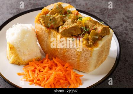 traditional durban mutton bunny chow closeup on plate on the table ...