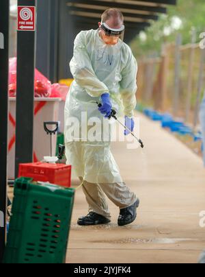 AUSMAT staff at a PPE Doffing Station , disposing of "Dirty" PPE at the ...
