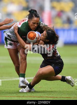 Amy Turner (left) of the Maori All Stars is tackled by Jasmine Peters ...