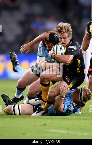 Jake McIntyre of the Western Force (left) is tackled by Robbie Valetini ...