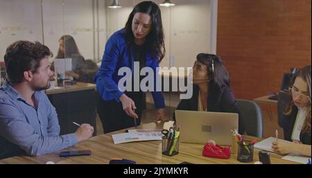 Boss speaking to employees at night Stock Photo - Alamy