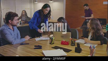 Boss speaking to employees at night Stock Photo - Alamy