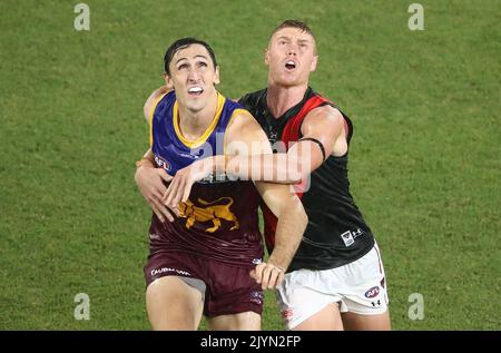 Essendon's Peter Wright in action with Brisbane's Oscar McInerney ...