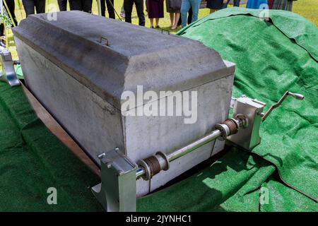 Casket about to be lowered into the ground in cemetery Stock Photo - Alamy