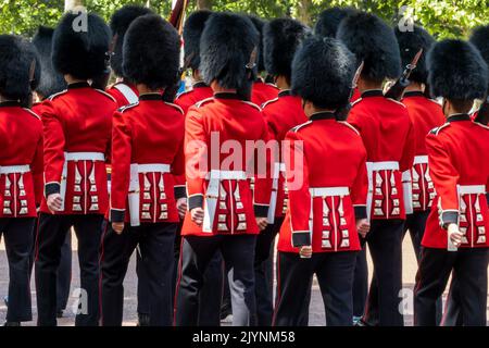 Queen royal british guards in red uniforms during guards changing parade on the Mall in London ...