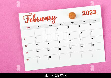 February 2023 calendar and wooden push pin on yellow background Stock ...