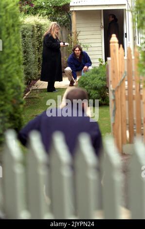 Mornington, Victoria, June 23, 2004. Police searching the yard at the ...