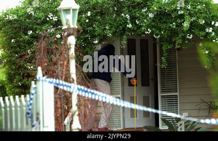 Mornington, Victoria, June 23, 2004. Police searching the yard at the ...