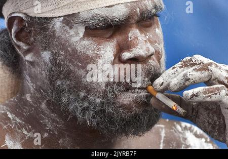 An Aboriginal man smokes a cigarette at a Dance Festival in Laura ...