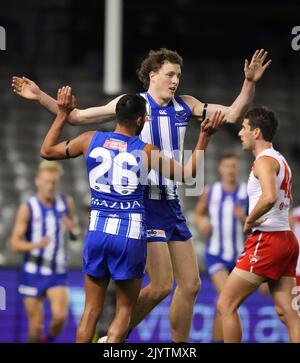Nick Larkey of North Melbourne celebrates with team mates after kicking ...