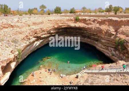 March 22 2022 - Bimmah sinkhole, Oman: People enjoy one of the world ...