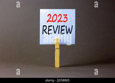 2023 Review symbol. White paper with words 2023 Review, clip on wooden ...