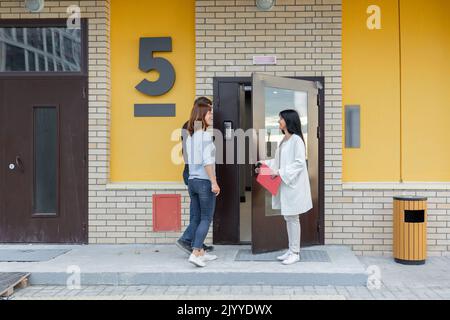 Realtor shows apartment in new building, handing keys to young couple ...