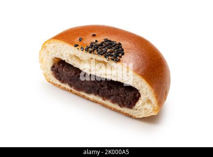 Anpan, cut in half, placed on a white background. Anpan is a Japanese ...