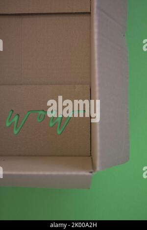 Wow word with cardboard box. Brown folded card box Stock Photo - Alamy