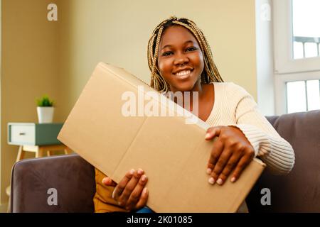 african american woman packing things in a box for moving Stock Photo ...