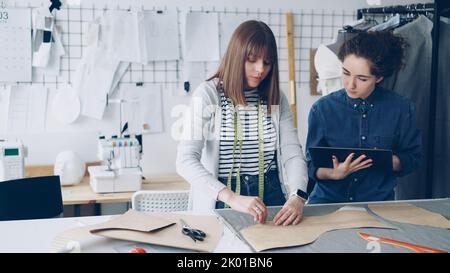 Fashion designer drawing outlines in atelier, preparing sketch and ...