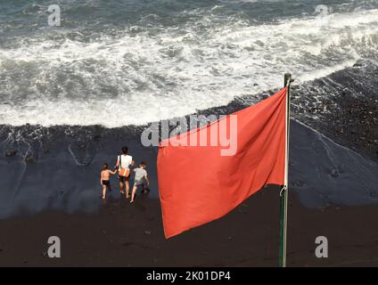 red flag meaning high hazard at the sea Stock Photo - Alamy