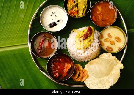 Kerala Ona sadya Onam feast - vegetarian thali served on a round plate ...