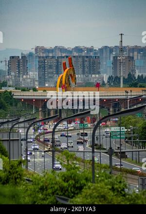 An aerial vertical shot of a highway with many transportations in ...