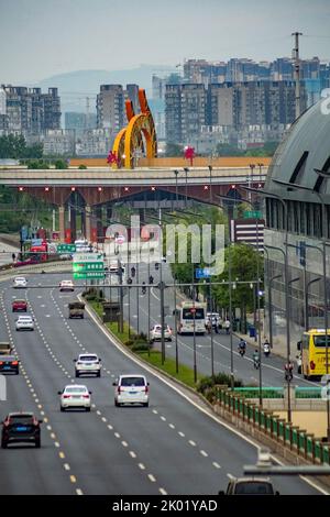 An aerial vertical shot of a highway with many transportations in ...