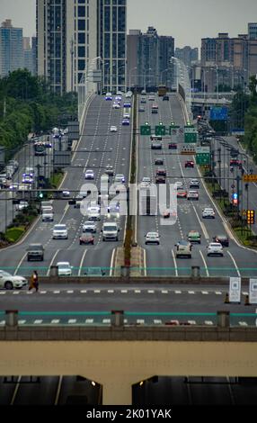An aerial vertical shot of a highway with many transportations in ...