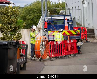 Engineers installing fibre optic cable underground Stock Photo - Alamy