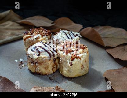 Two Cinnabon Chocobon (Soft Chocolate Buns) topped with rich cream ...