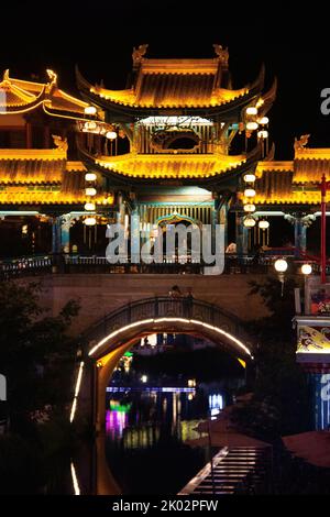 The illuminated buildings of the Impression Water street in Meishan ...