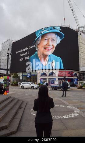 Piccadilly Circus displays a portrait of Queen Elizabeth II in London ...