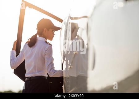 Chinese pilot opening helicopter door Stock Photo - Alamy