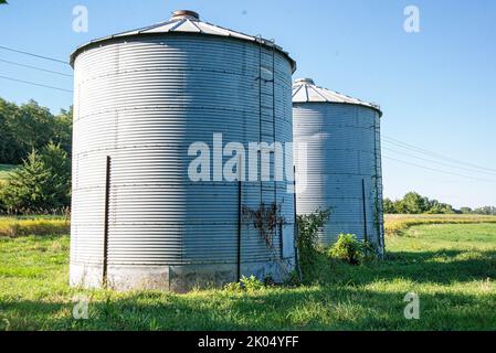 Two old grain bins on a farm Stock Photo - Alamy