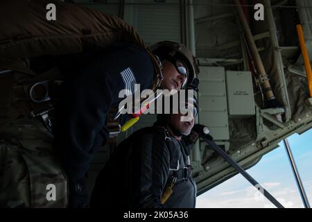 A U.S. Army parachute rigger (left) assigned to the 173rd Airborne ...