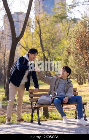 Happy Chinese college students talking on campus Stock Photo - Alamy