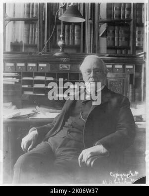 Frances Benjamin Johnston seated at a desk in her studio/office, with ...