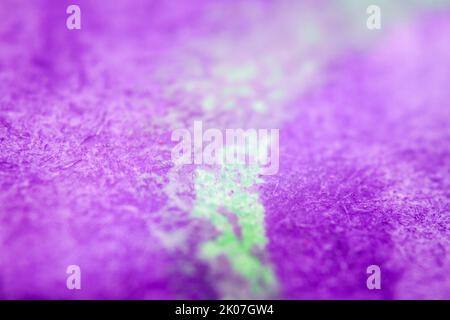 Extreme close up of purple watercolor on paper texture Selective focus ...