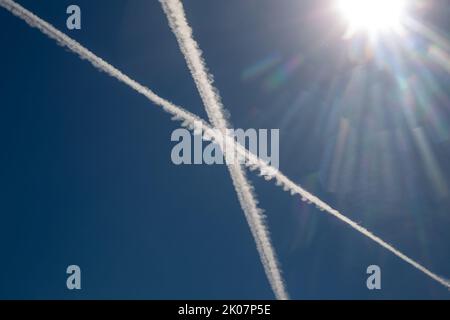 Blue sky with many contrails or chemtrails Stock Photo - Alamy