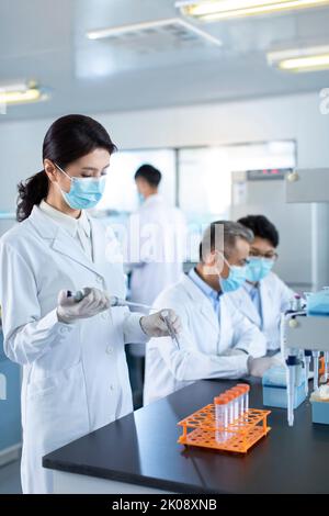 Chinese scientists examining medical sample in laboratory Stock Photo ...