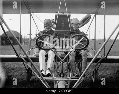 A photograph of a Curtiss Pusher biplane in flight, taken at the ...
