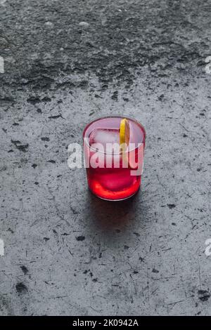 bright pink magenta blueberry shrub cocktail drink with lemon wheel and ...