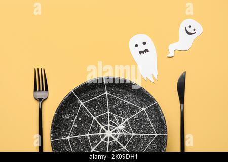 Table setting with paper ghosts for Halloween party on color background ...