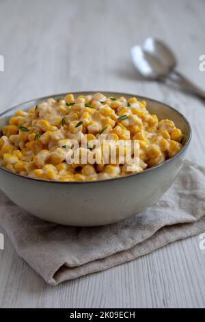 Homemade Slow Cooker Creamed Corn in a Bowl, side view. Space for text ...