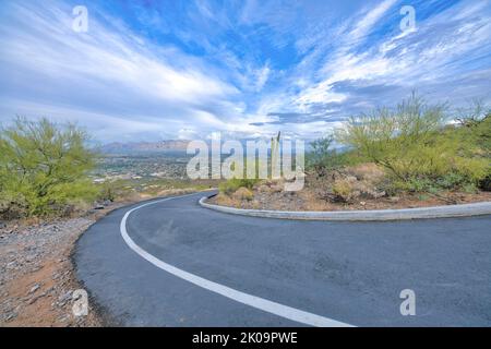 Downhill asphalt u-shaped bike path and walking pathway on a slope at ...
