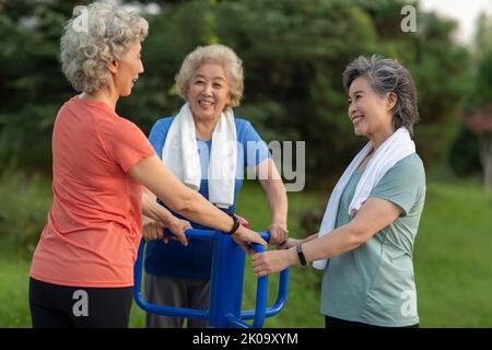 Happy senior Chinese friends exercising in park Stock Photo - Alamy