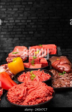 Assorted Raw Beef Meats on a Table with a Modern White Kitchen ...