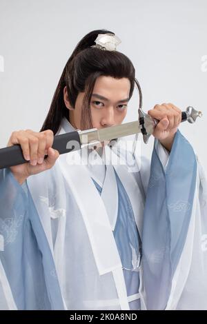Young Chinese swordsman in ancient costume Stock Photo - Alamy