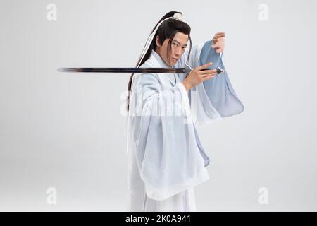 Young Chinese swordsman in ancient costume Stock Photo - Alamy