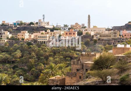 View of mountain village Misfat Al Abriyeen surrounded by the garden ...