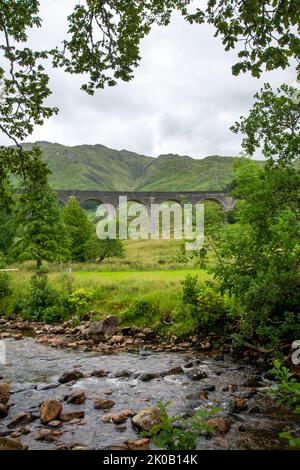 World famous bridge,framed by green trees,and narrow river,in the West ...