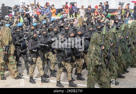 Royal Malaysian Navy troop marching with assault rifles and combat gear ...